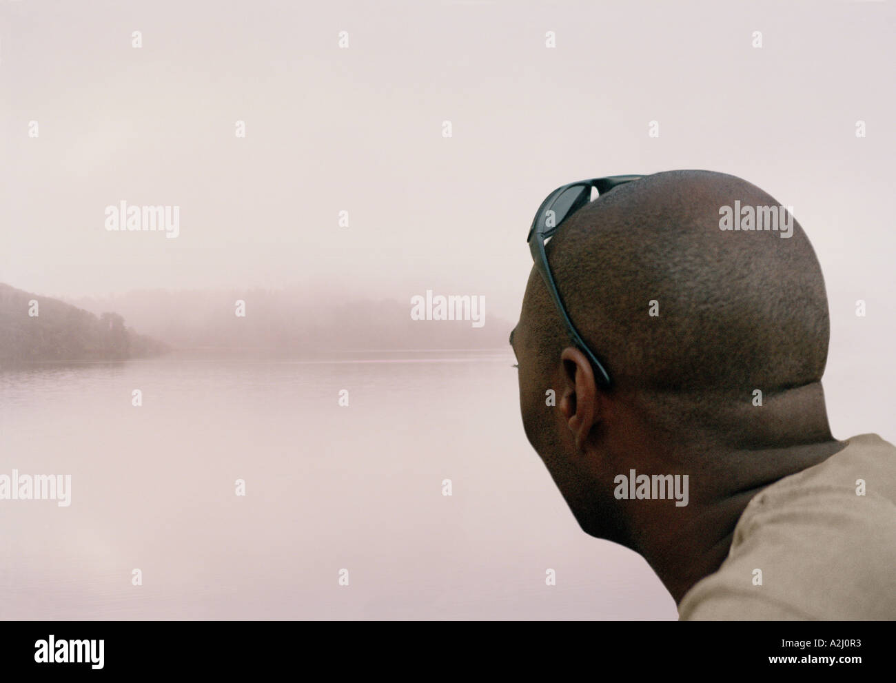 Back view of a black man looking across a lake Stock Photo - Alamy