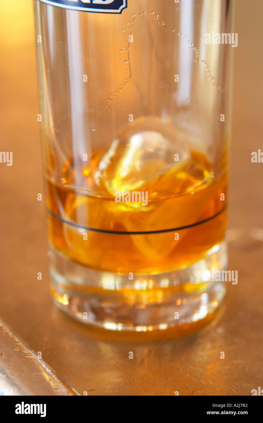 A glass of Ricard 45 pastis on a zinc bar in a cafe in Paris. Part of a ...