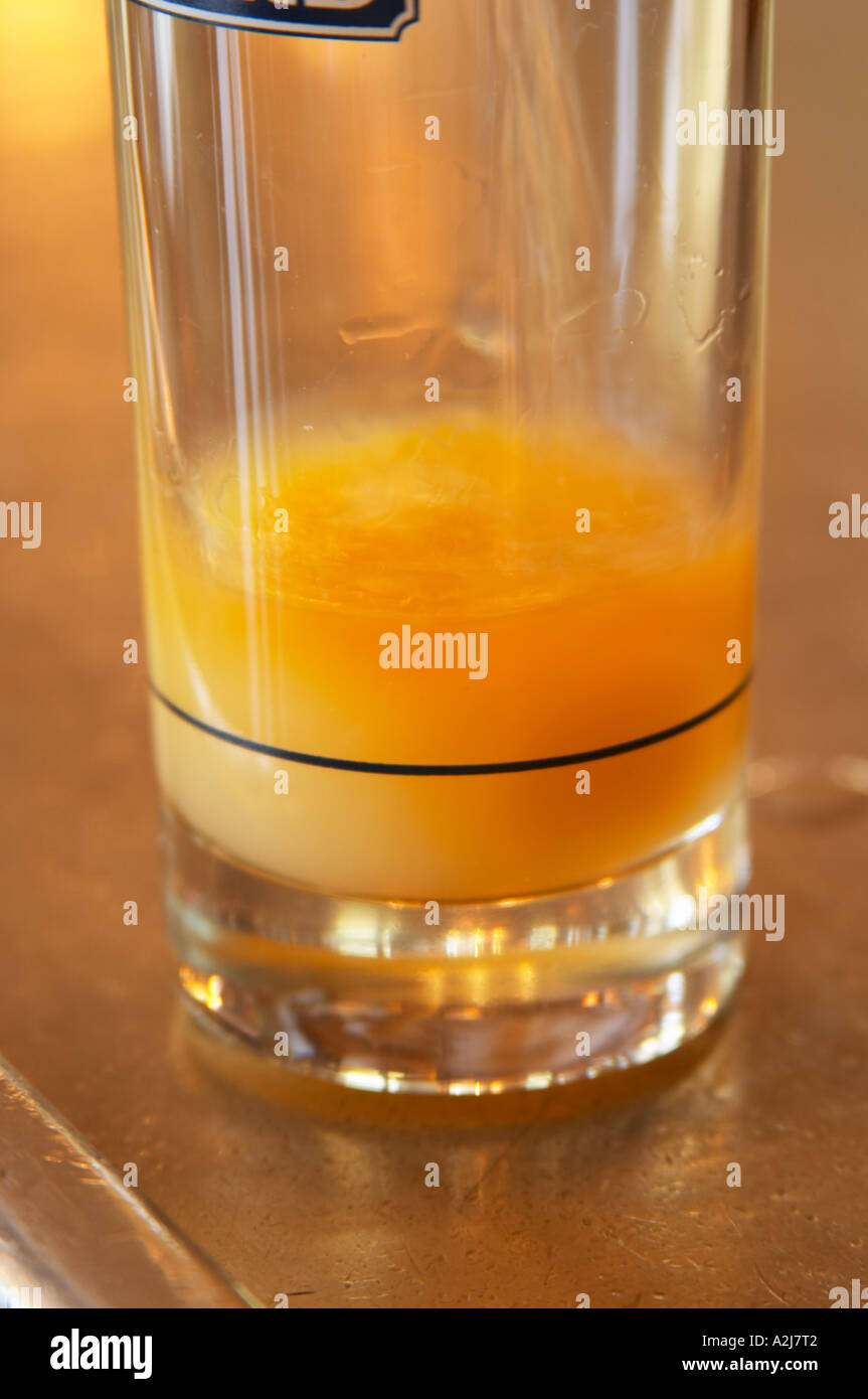 A glass of Ricard 45 pastis on a zinc bar in a cafe in Paris. Part of a ...