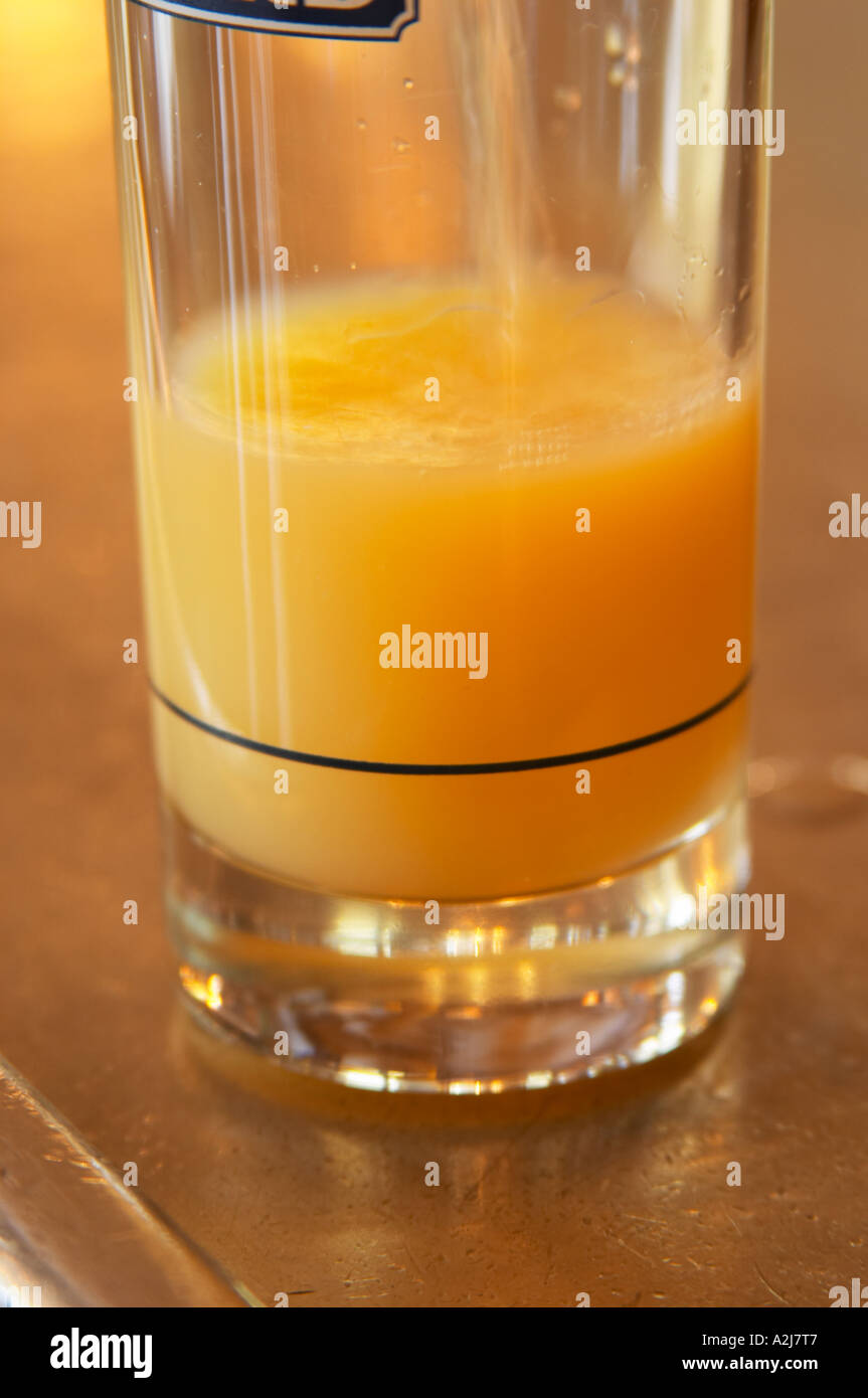 A glass of Ricard 45 pastis on a zinc bar in a cafe in Paris. Part of a ...