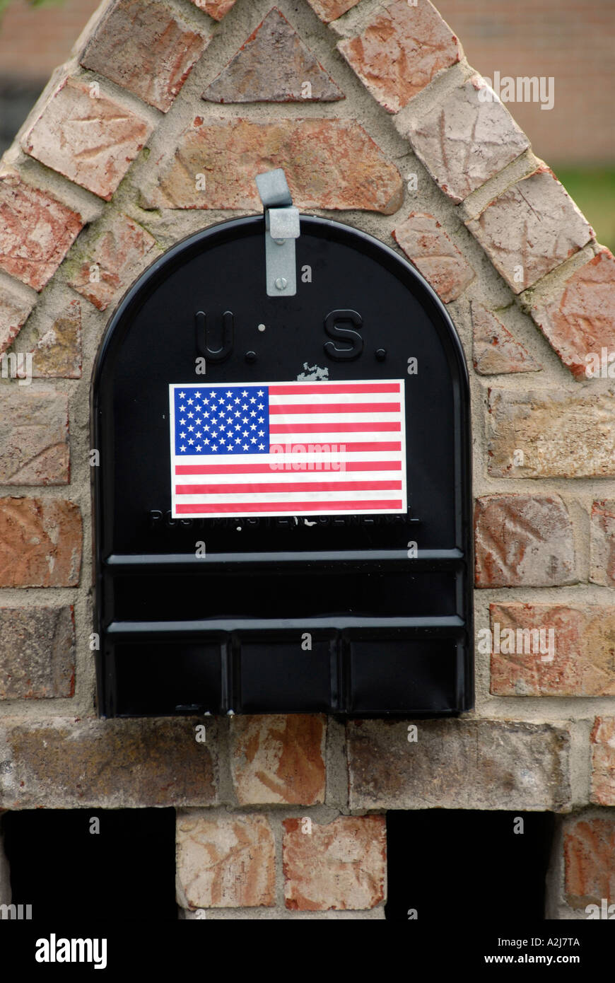 American flag is displayed on the postal mail box of a residential ...