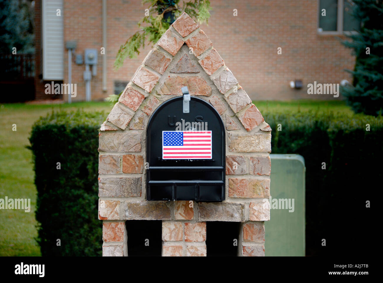 American flag is displayed on the postal mail box of a residential ...