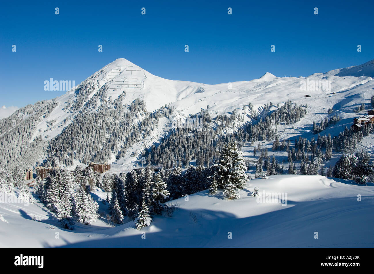 Winter scenic landscape with deep snow and mountains with a blue sky ...