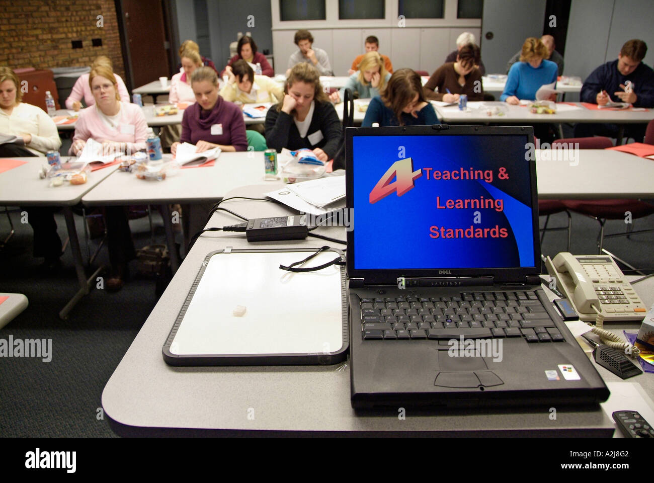 Business education seminar is conducted by a female instructor to a ...