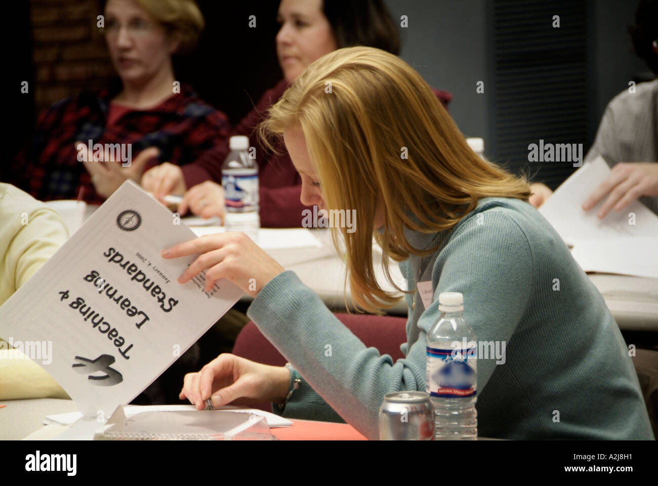 Business education seminar is conducted by a female instructor to a ...