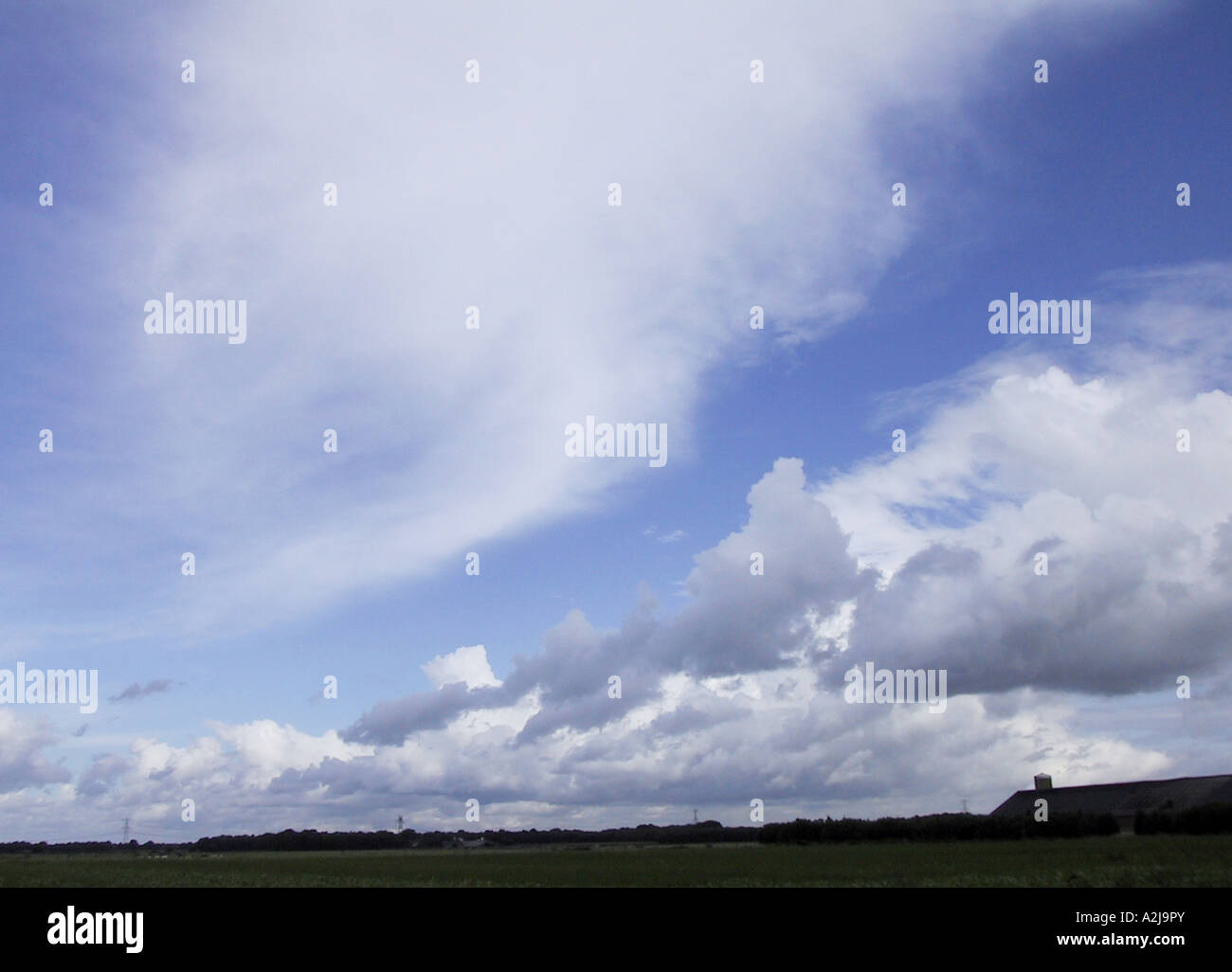Cloud formations with blue sky and low horizon Stock Photo - Alamy