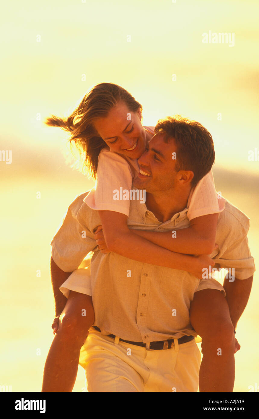 Man cranes his head backwards to look at the smiling woman he happily ...