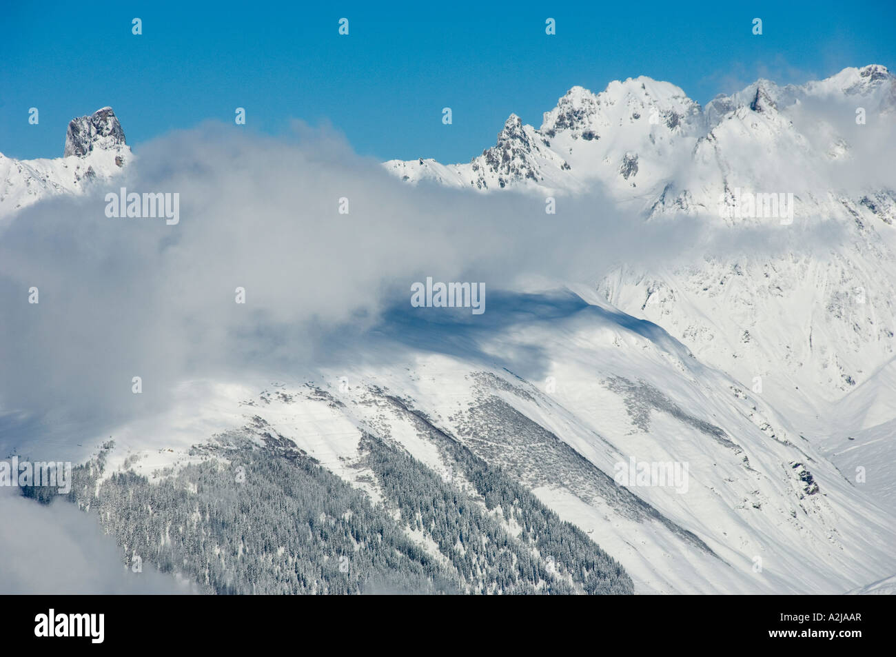 alpine winter landscape with high mountains and clouds Stock Photo - Alamy