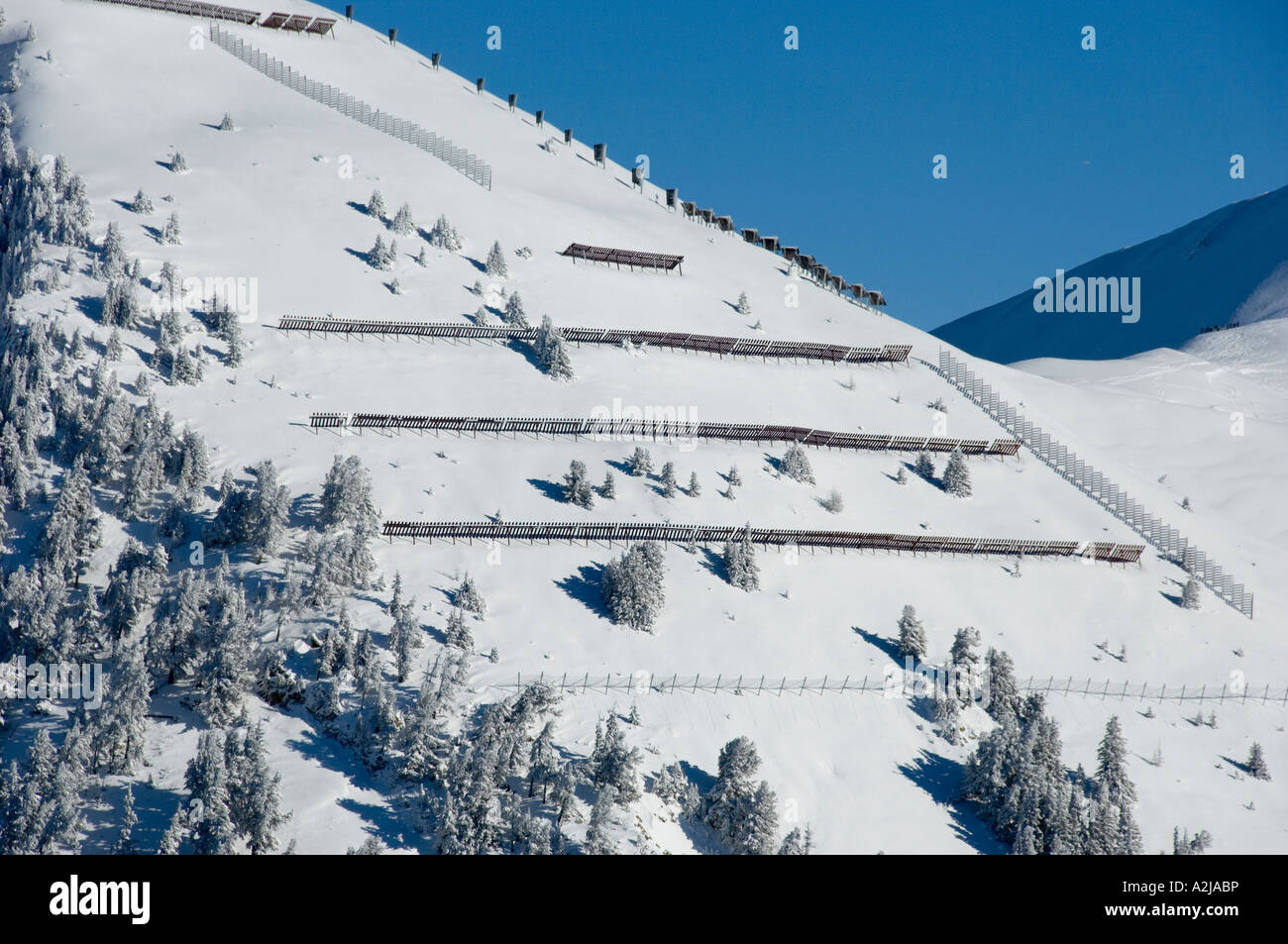 Avalanche protection barriers on a steep alpine hillside Stock Photo ...