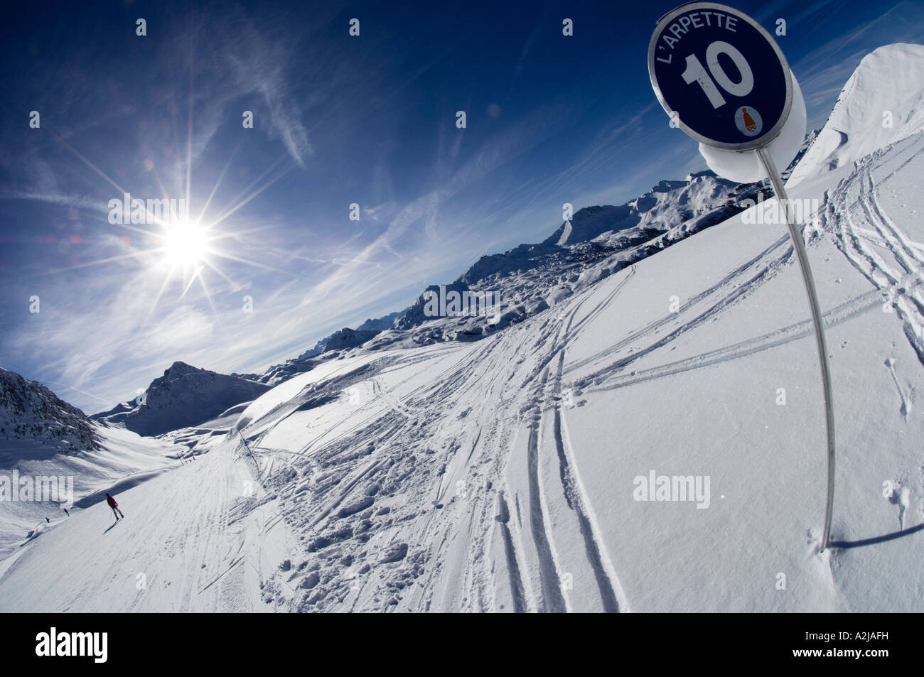 Blue ski run piste sign and sun in a dark blue sky Stock Photo - Alamy