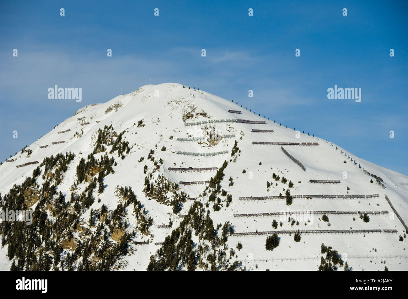 Avalanche protection barriers on a steep hillside Stock Photo - Alamy