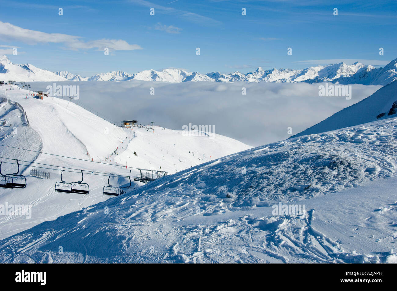 Alpine winter landscape with chairlift and cloud inversion Stock Photo ...