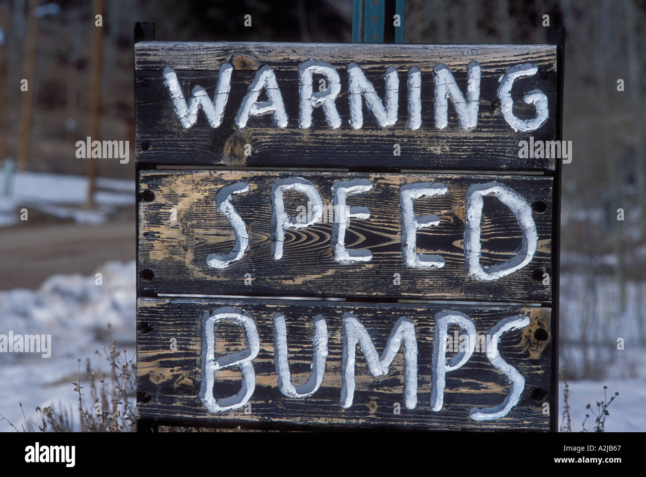 Rural wooden traffic sign Danger Speed Bumps Stock Photo - Alamy