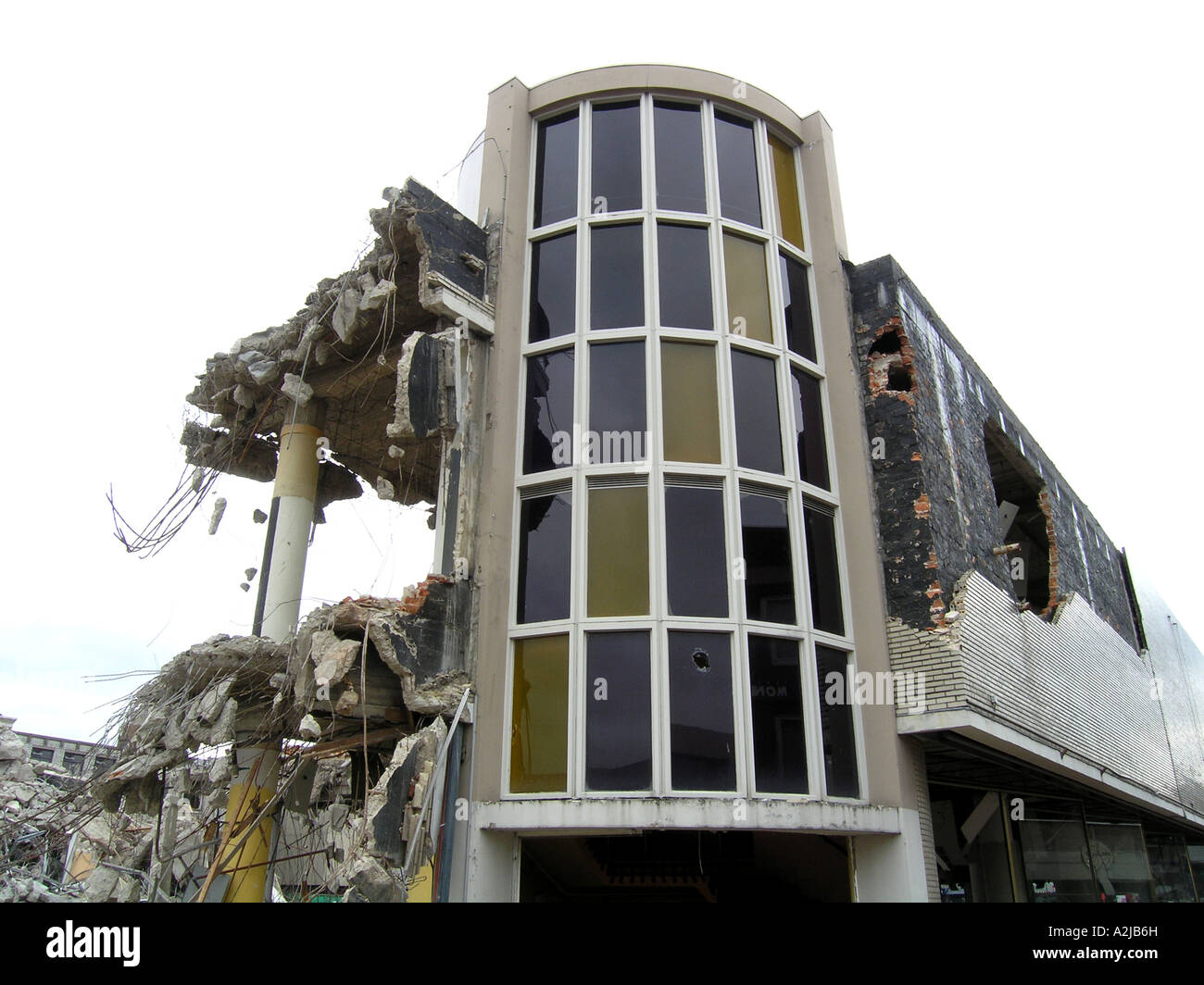 part of broken down building still standing among rubble and debris ...