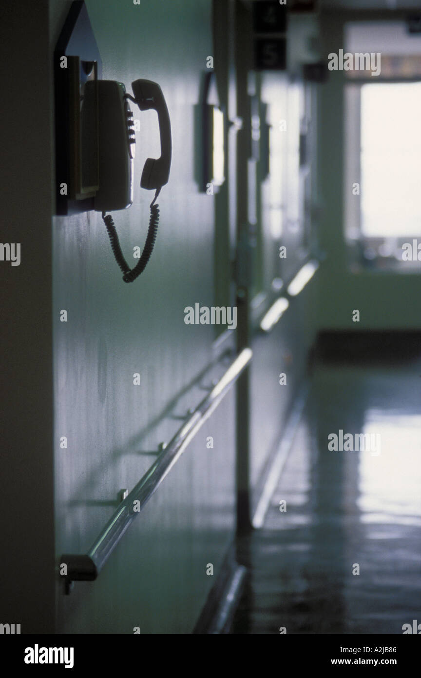 A wall mounted telephone hangs on an empty hospital corridor Stock ...