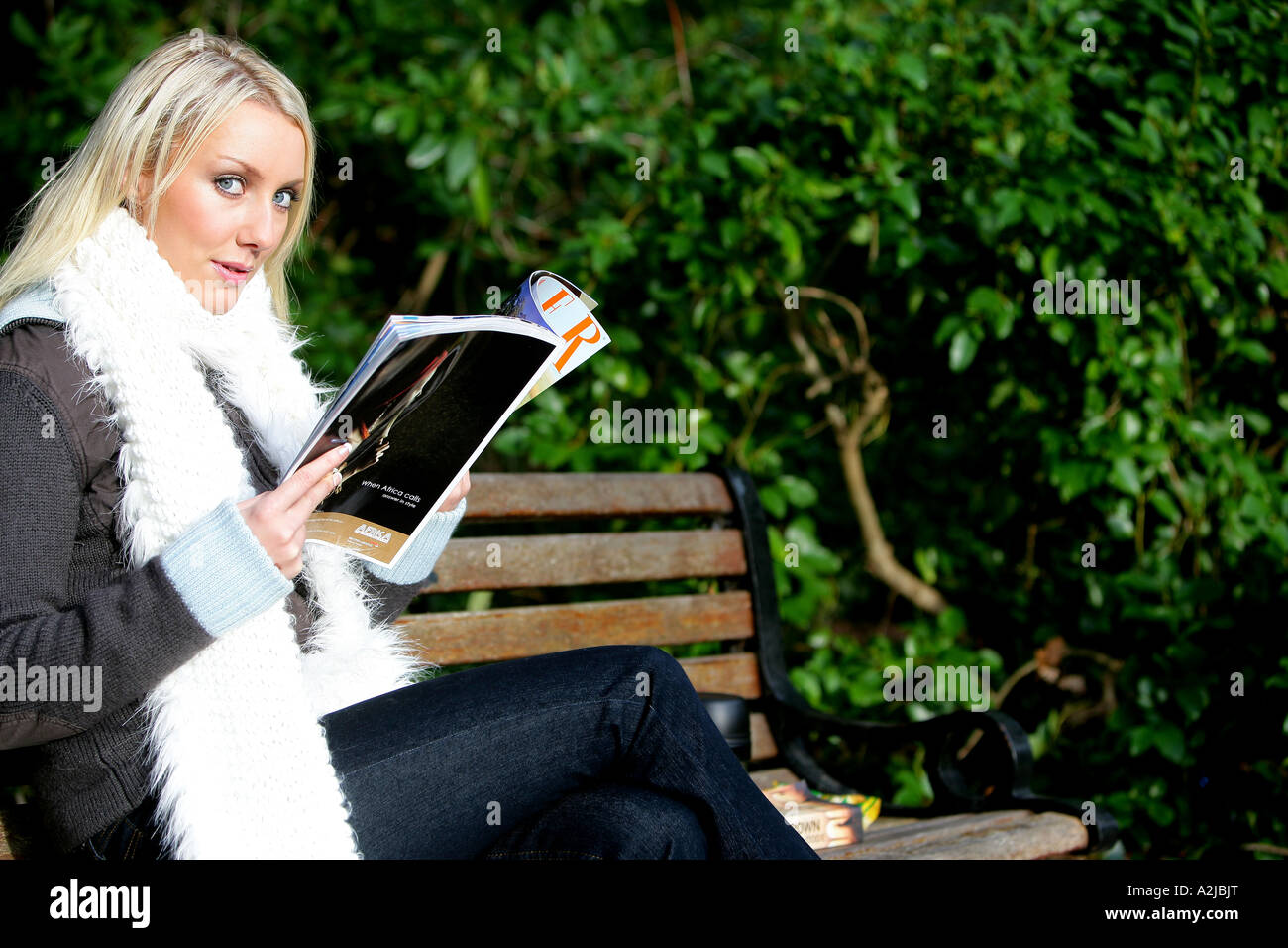 Young Woman Reading a Magazine in a Park Model Released Stock Photo - Alamy