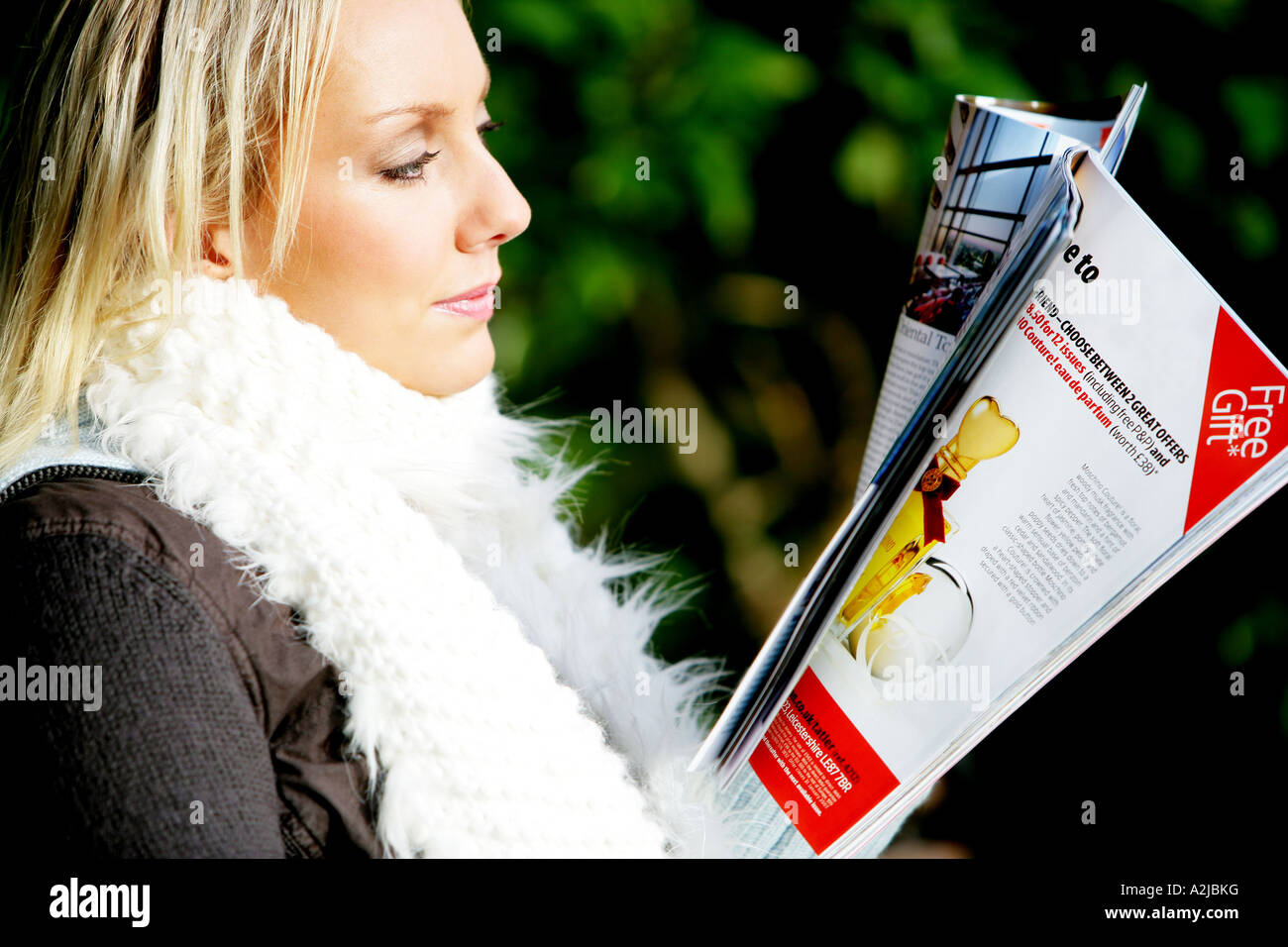 Young Woman Reading a Magazine in a Park Model Released Stock Photo - Alamy