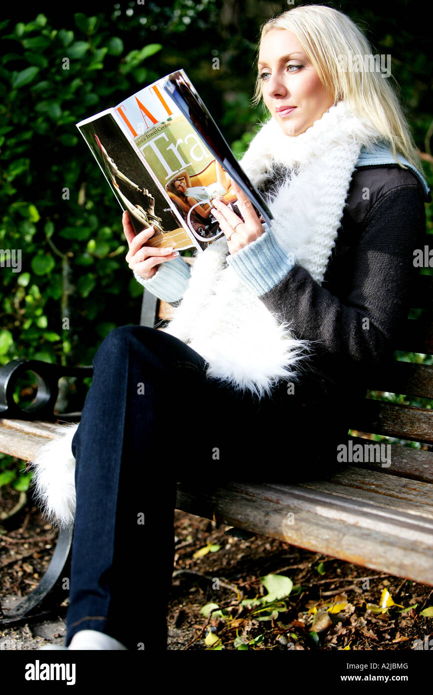 Young Woman Reading a Magazine in a Park Model Released Stock Photo - Alamy