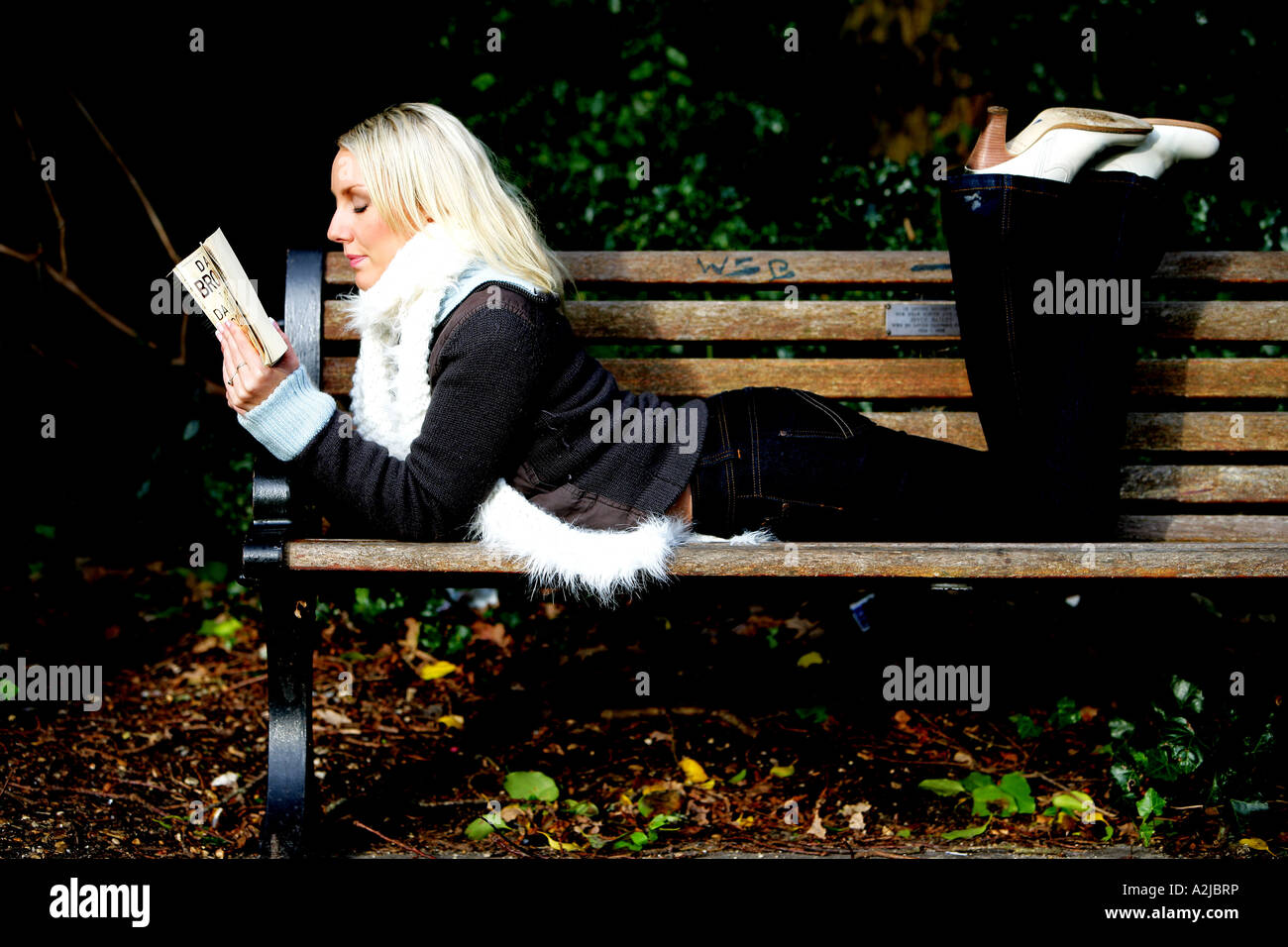 Young Woman Reading a Magazine in a Park Model Released Stock Photo - Alamy