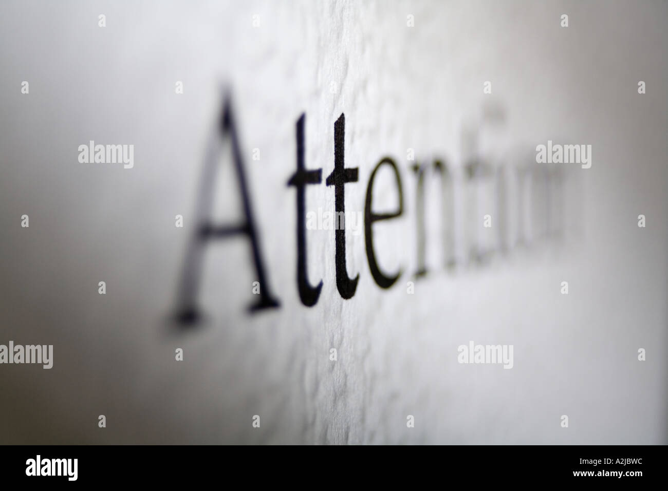 the word attention printed on to texture paper Stock Photo - Alamy