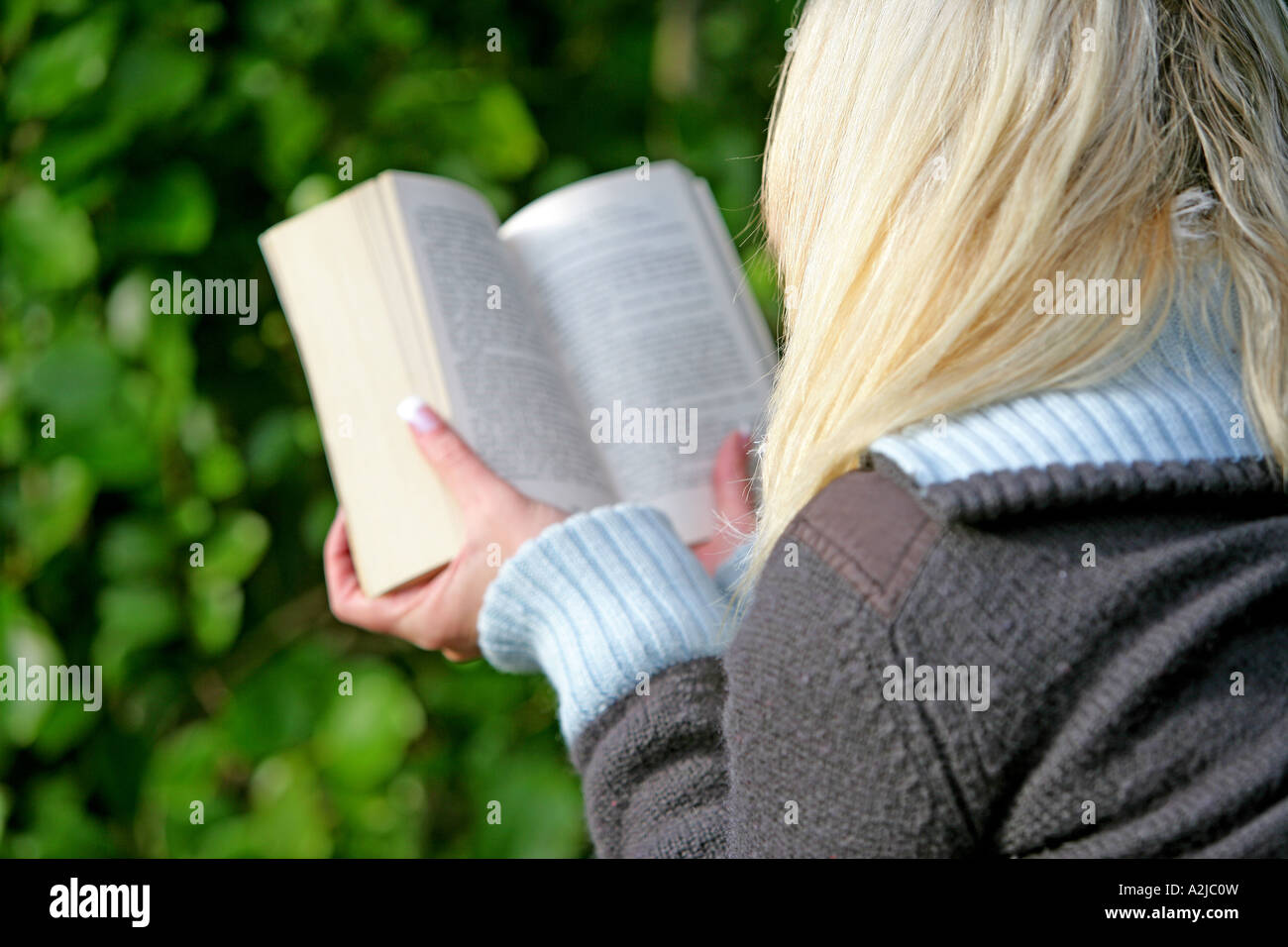 Young Woman Reading a Magazine in a Park Model Released Stock Photo - Alamy