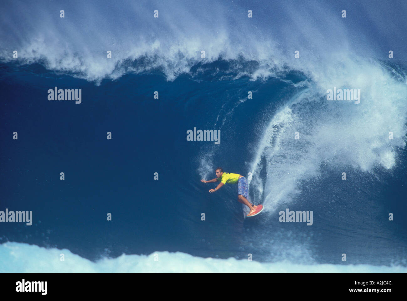 Surfing man begins to shoot the curl of a large wave Stock Photo - Alamy