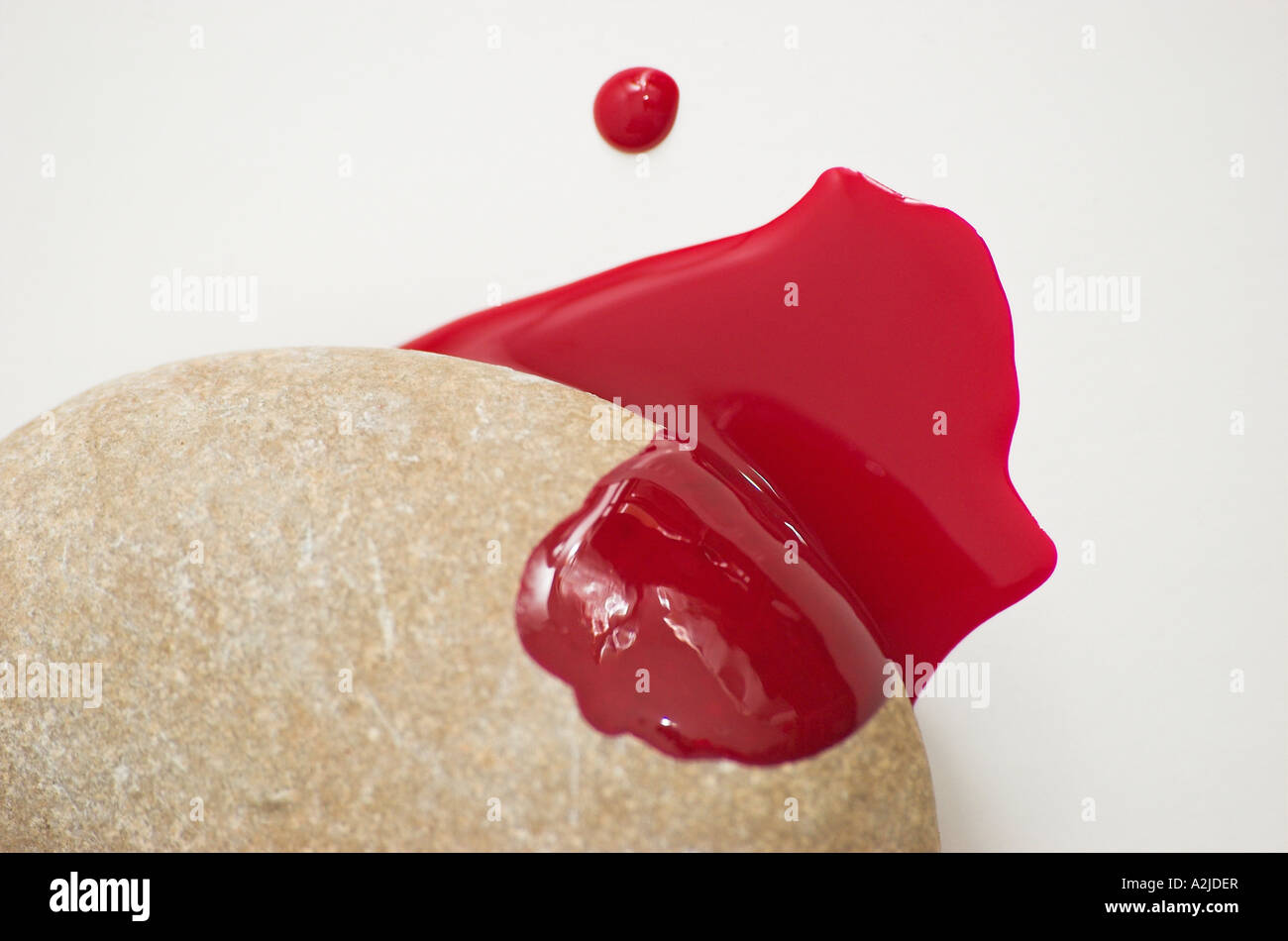 Red liquid on pebble Stock Photo - Alamy