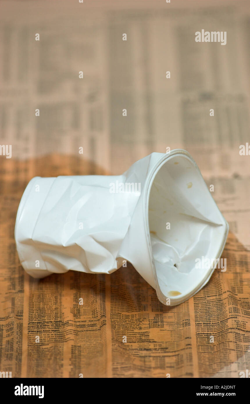 Crushed coffee cup and spilt coffee over financial newspaper Stock ...