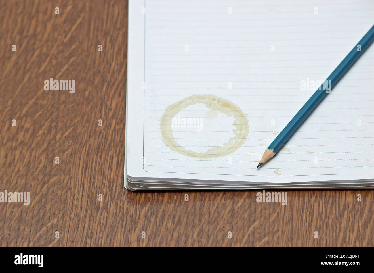 Coffee stain on note book with pencil Stock Photo - Alamy