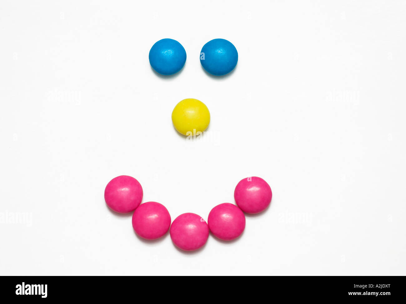 Colourful sweets forming smiley face on black background Stock Photo ...