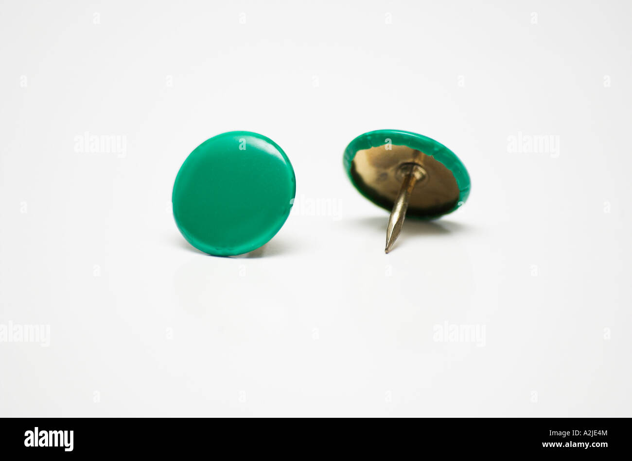 Two drawing pins against white background close up Stock Photo - Alamy