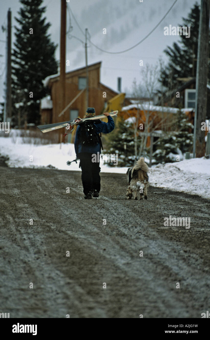 dana berry and her dog pascal walking up dirt road after a day of ...