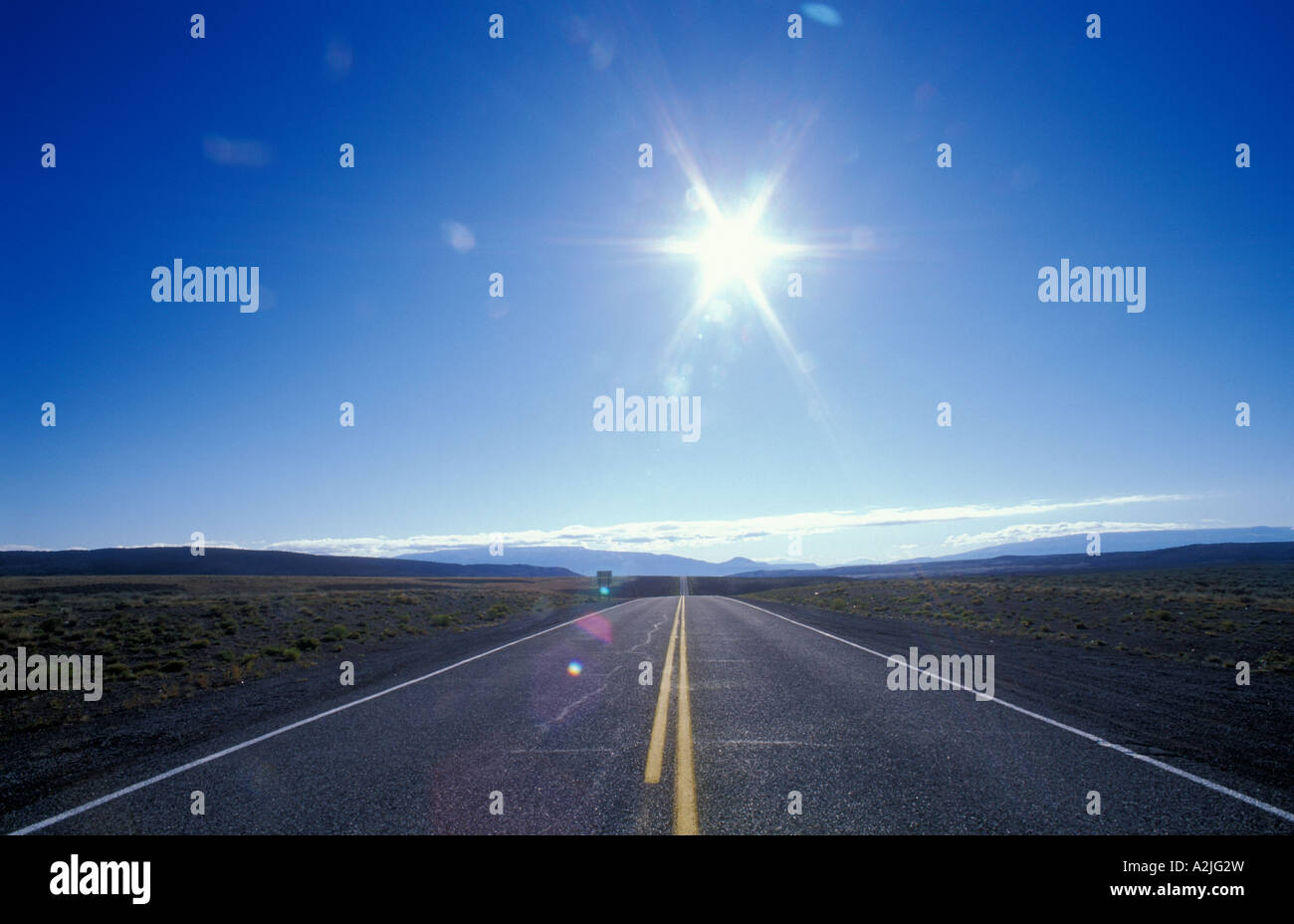 USA Utah road leading to horizon with sun burst in the sky Stock Photo ...