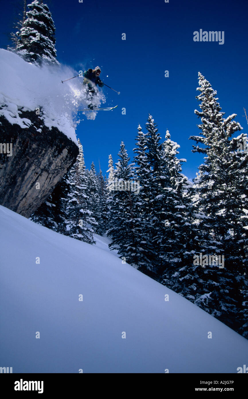 matt basham jumping off rock while backcountry skiing near telluride ...