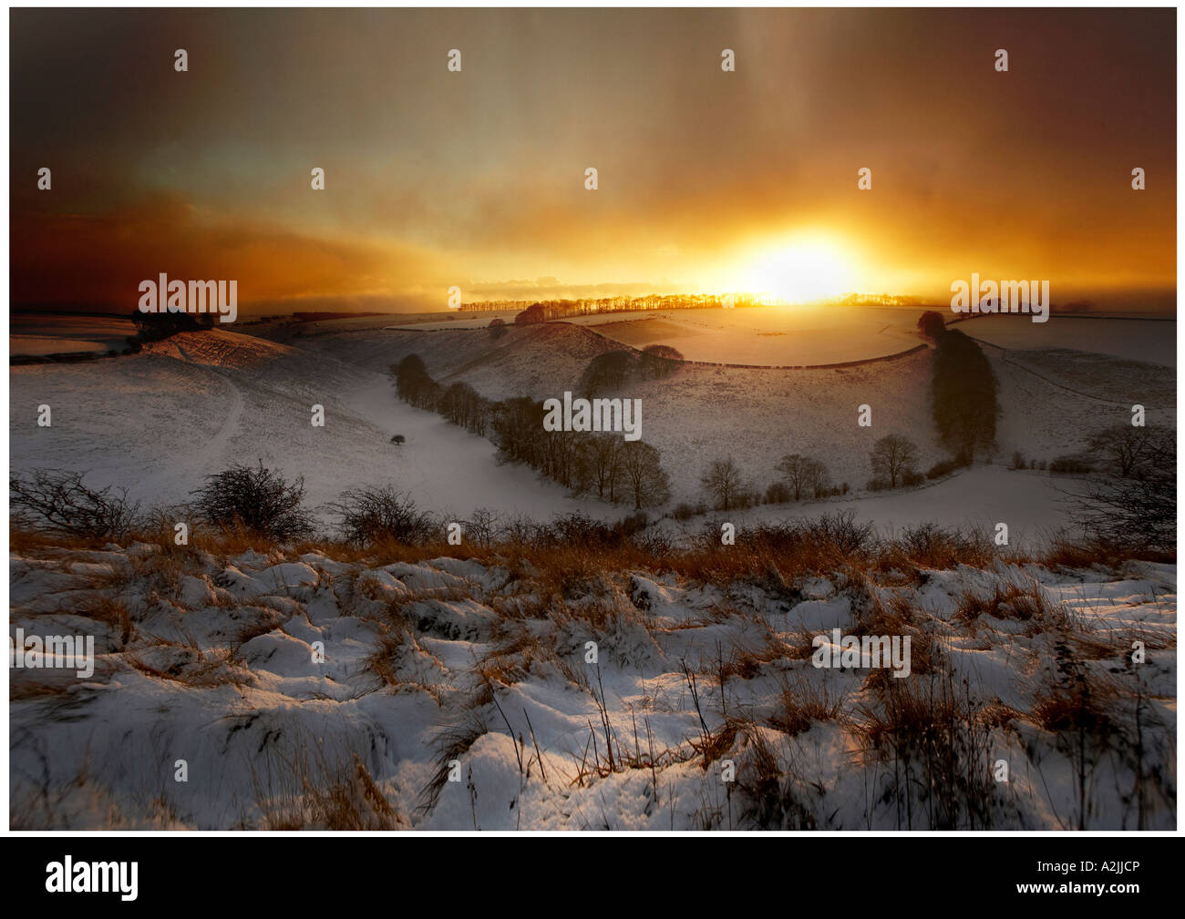 Late evening sun bursts through the mist after a snow fall over the ...