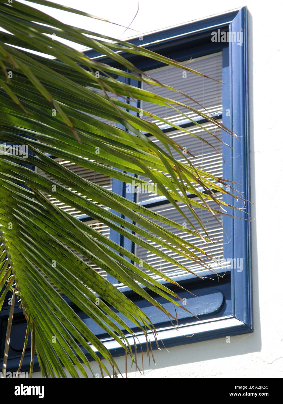 Blue painted shuttered window mediterranean Stock Photo - Alamy