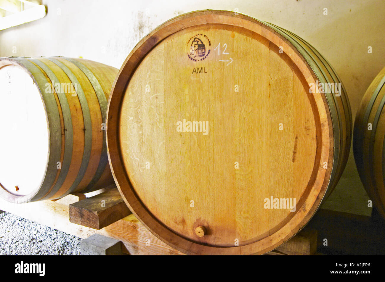 The barrel aging cellar with large oak barrels (demi muids) containing ...