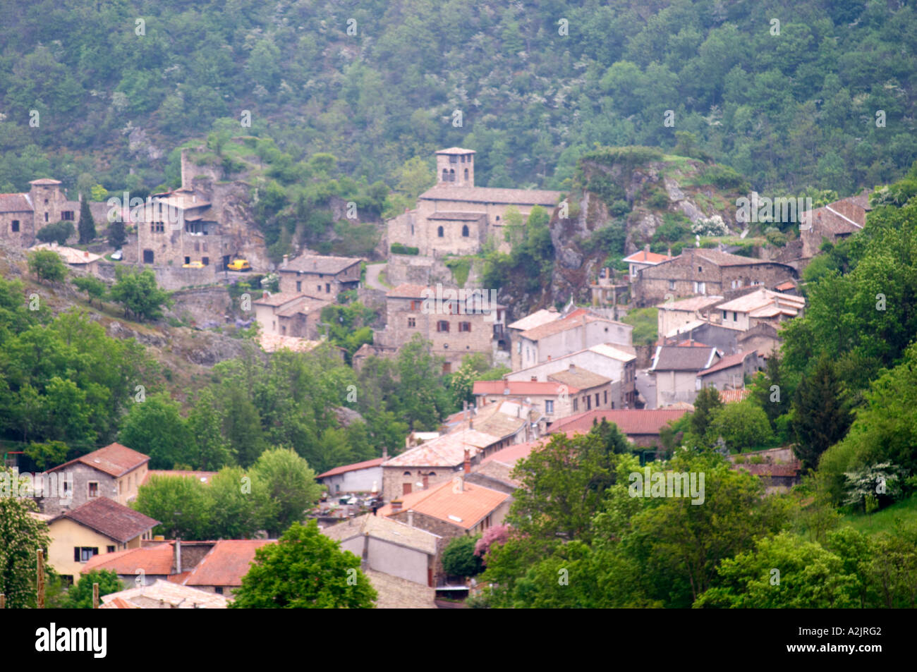 The village of Malleval with the old stone church and stone and ochra ...