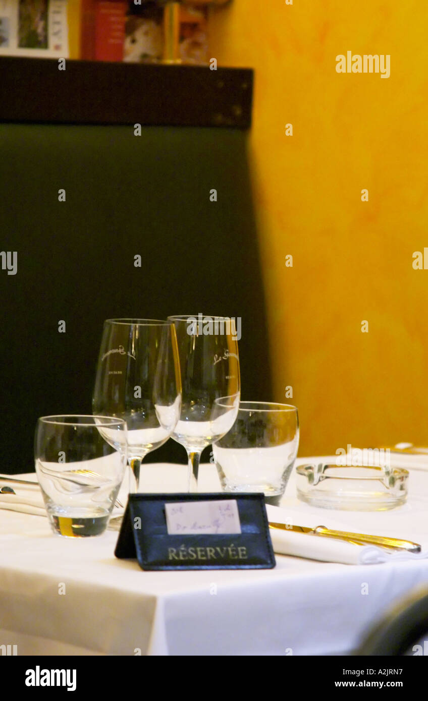 A restaurant table with a sign saying Reserve Réservé showing that the ...