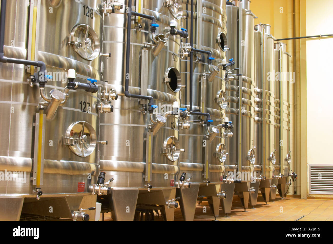 Stacks of stainless steel fermentation vats in various sizes and with ...