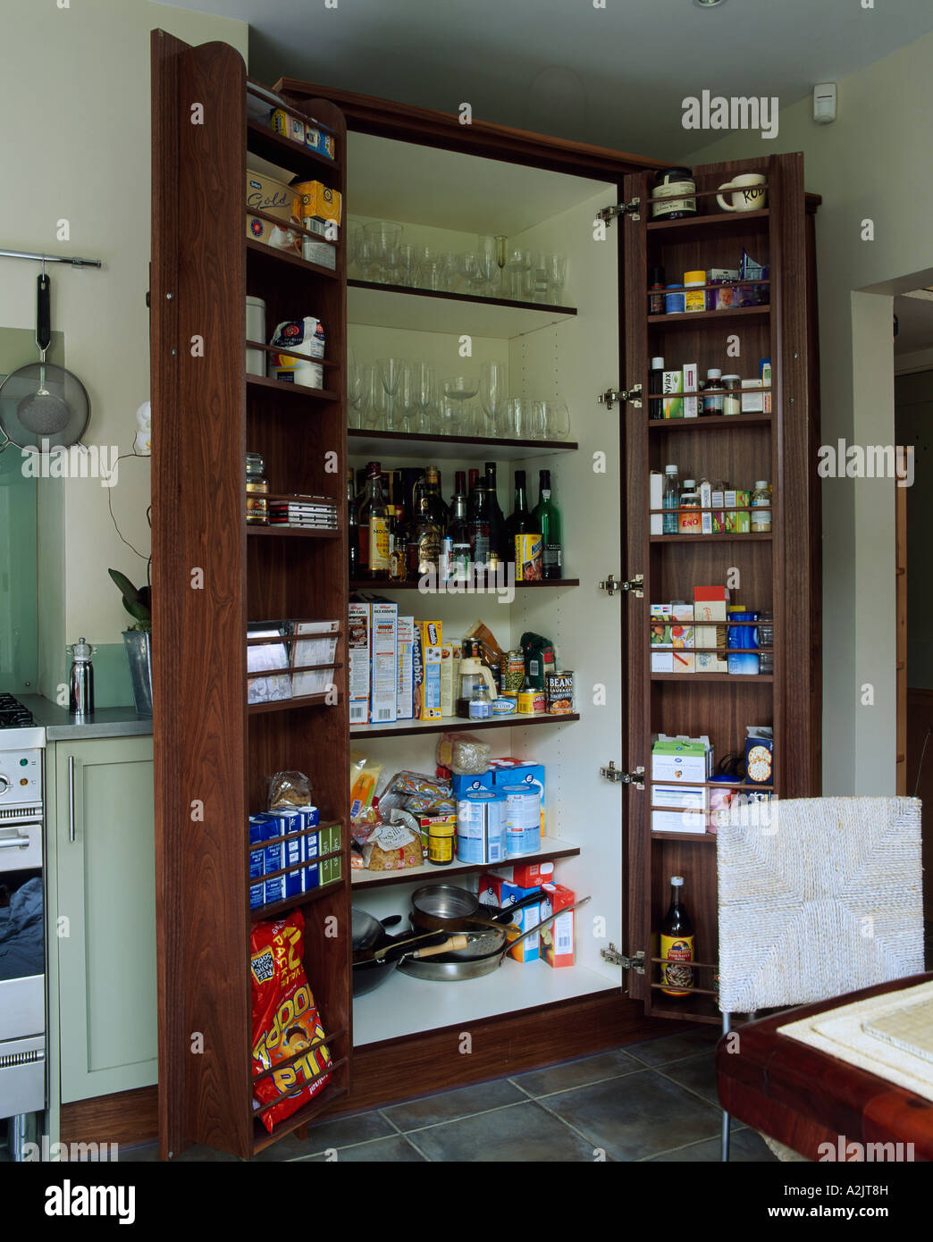 Storage cupboard with open doors and shelving Stock Photo - Alamy