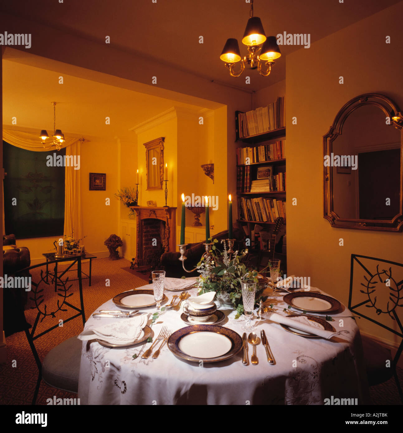 Table settings on white cloth with fixed lighting and candles Stock ...