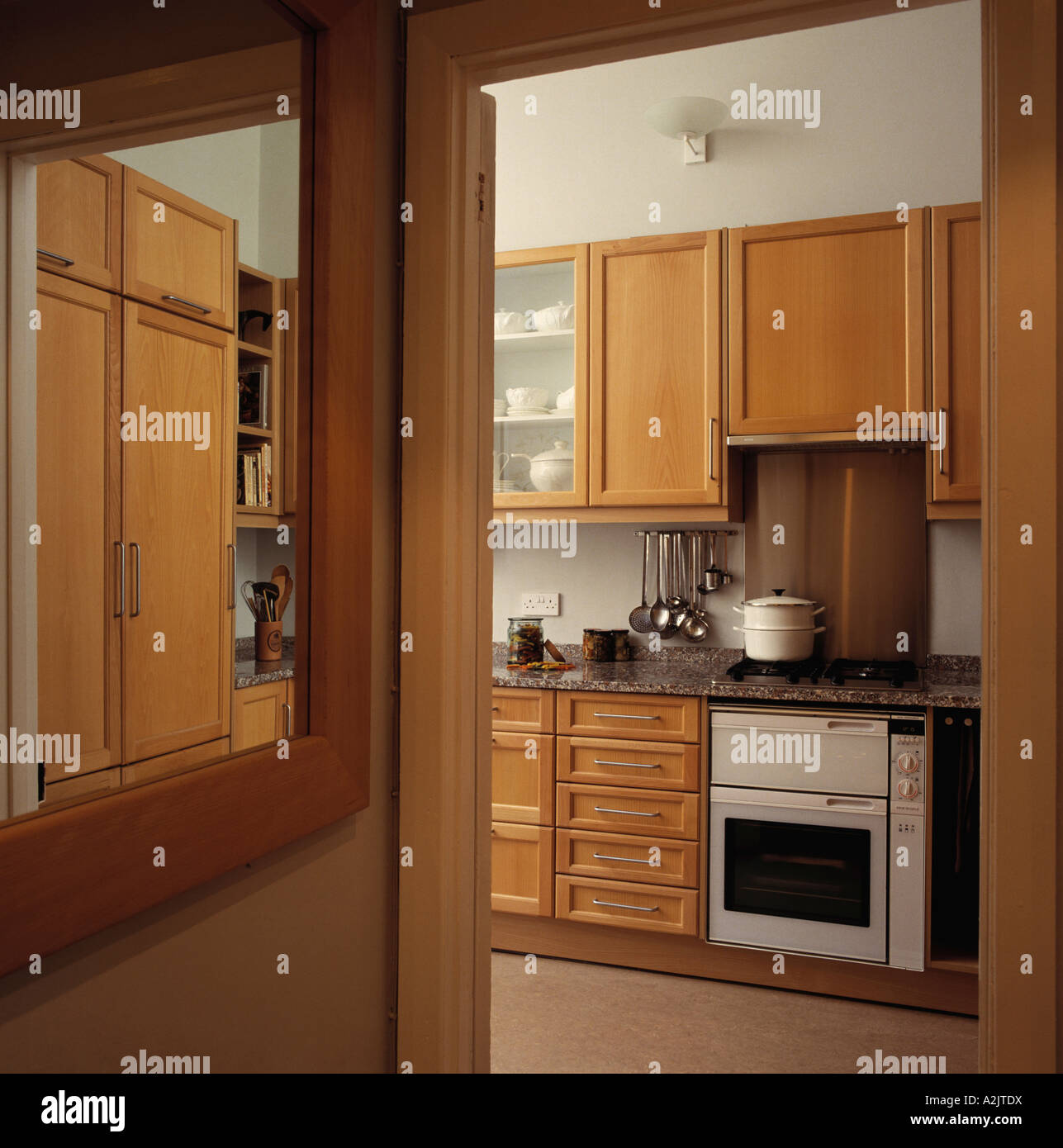 View through open door of wooden kitchen units and oven Stock Photo - Alamy