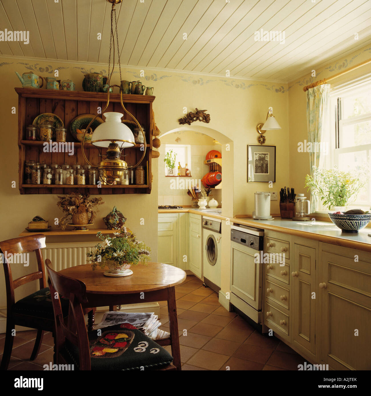 Pendant lamp with glass shade above small wooden table in kitchen Stock ...