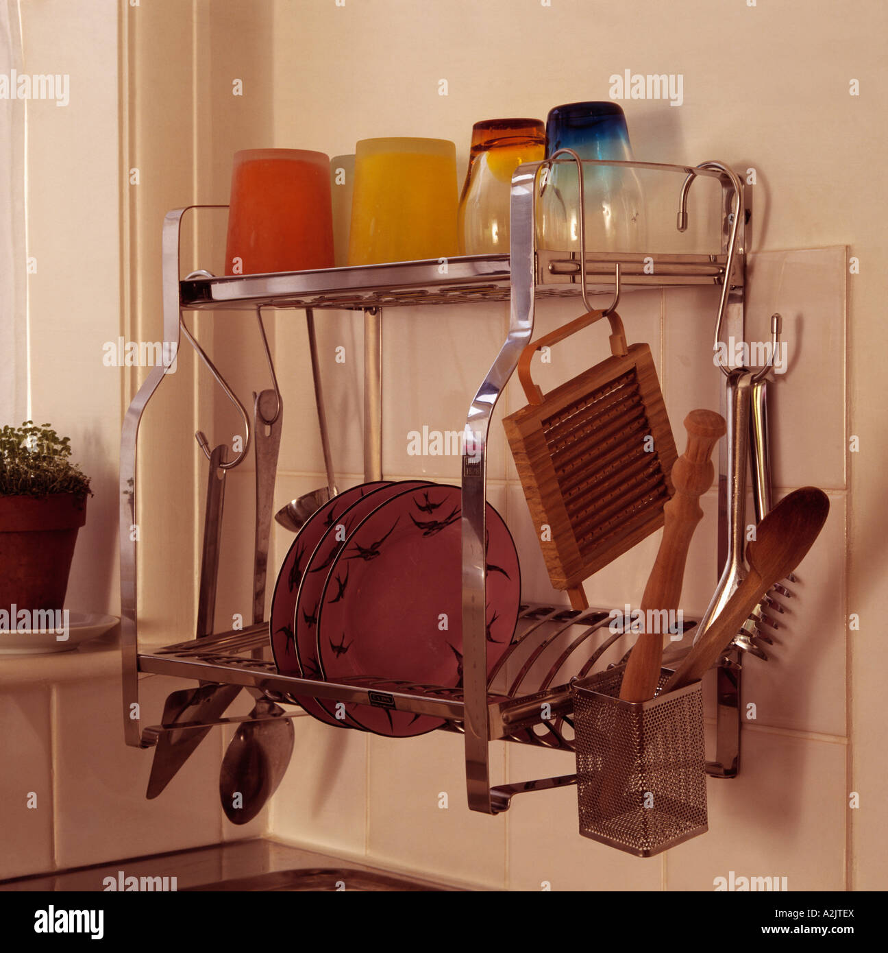 Metal plate rack with glasses and utensils Stock Photo - Alamy