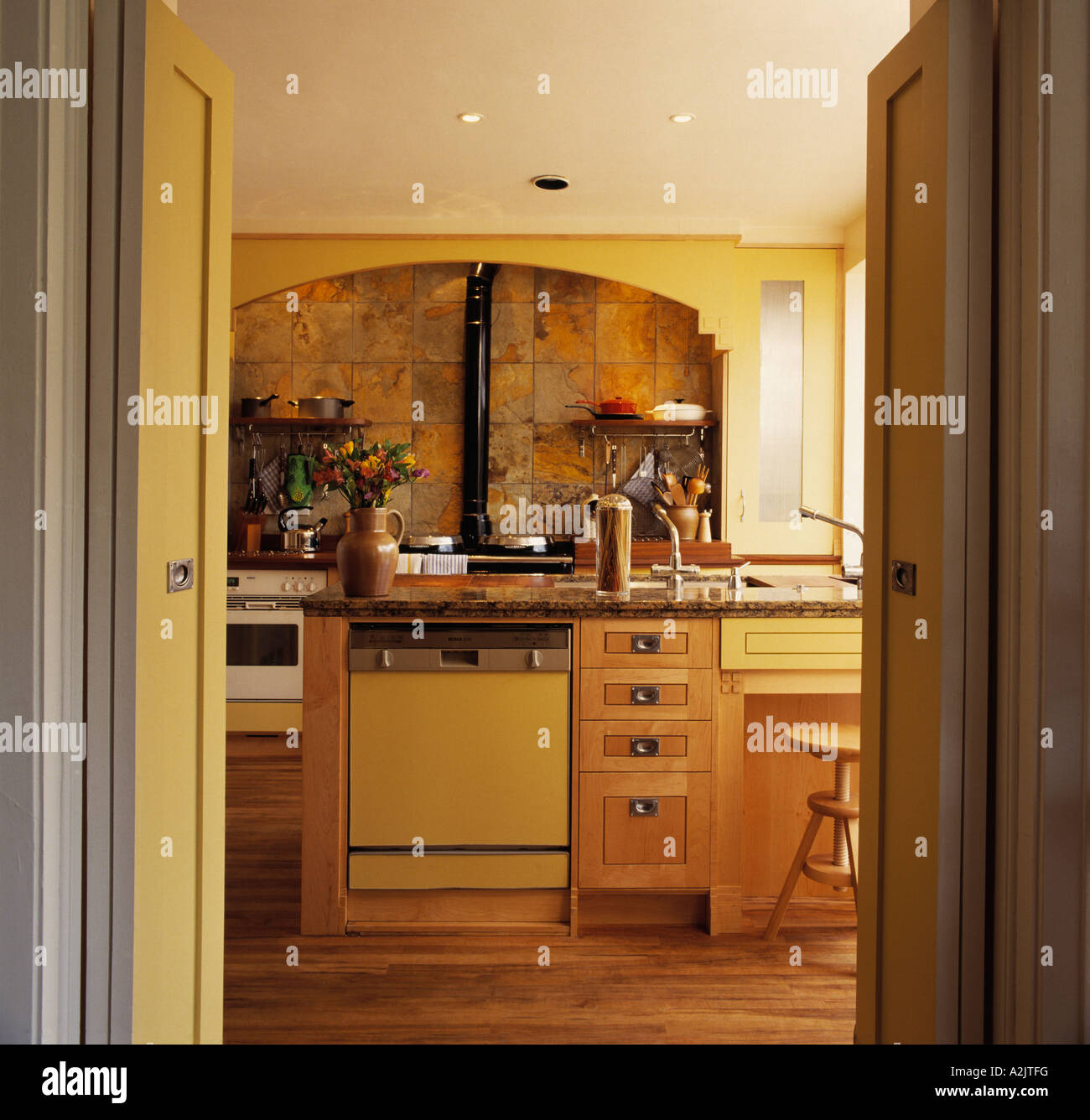 Open double doors with view to kitchen with dishwasher Stock Photo - Alamy