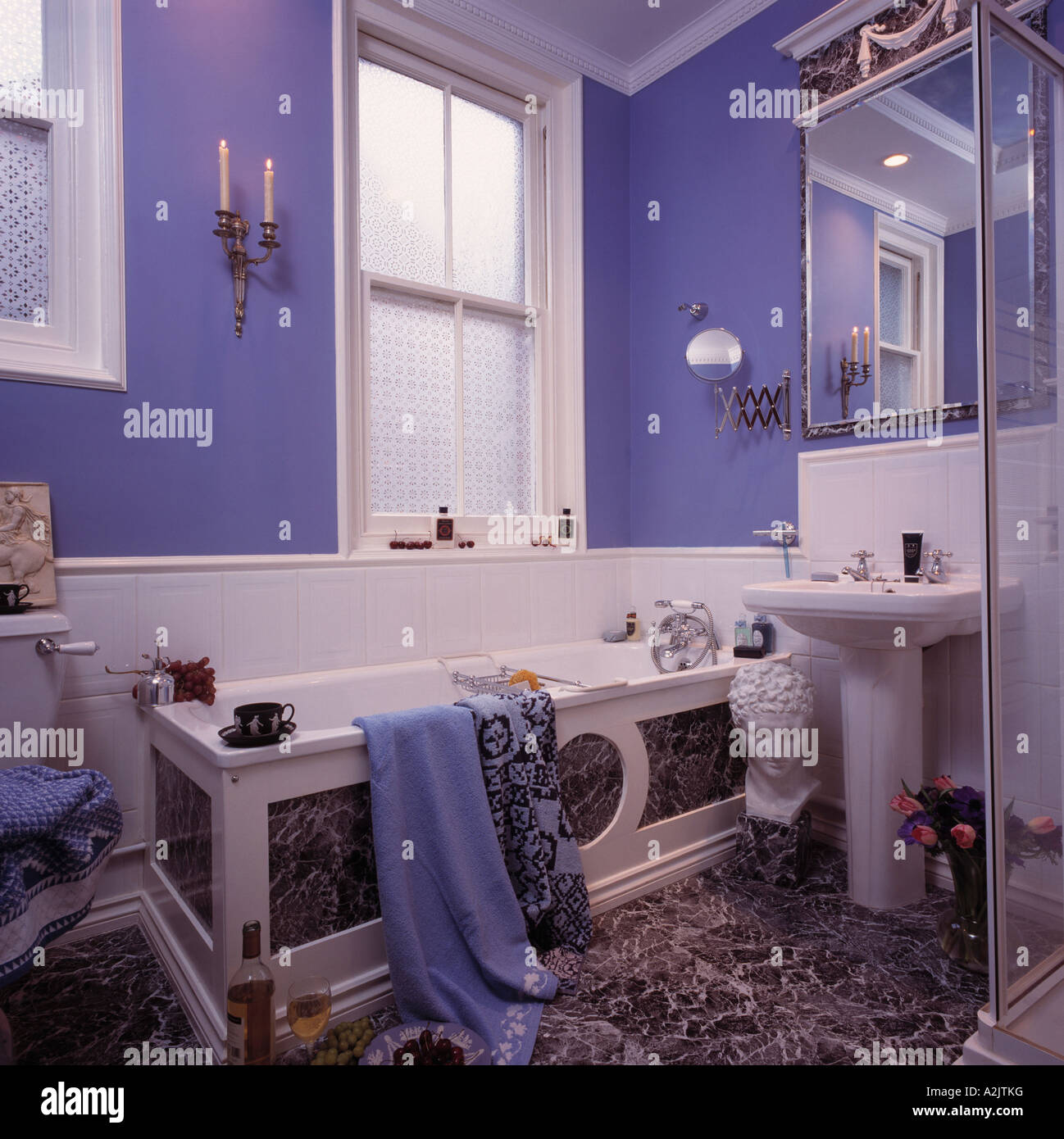 Blue bathroom with sculpture and patterned bath panel and floor Stock ...