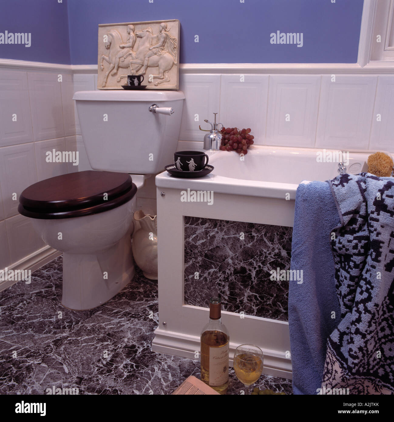 Patterned bath panel and sculpture above toilet in blue bathroom Stock ...