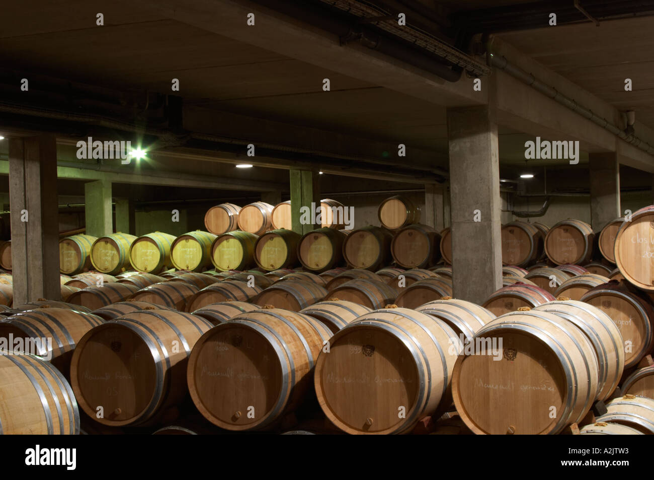 The modern barrel aging cellar with barriques pieces with maturing wine ...