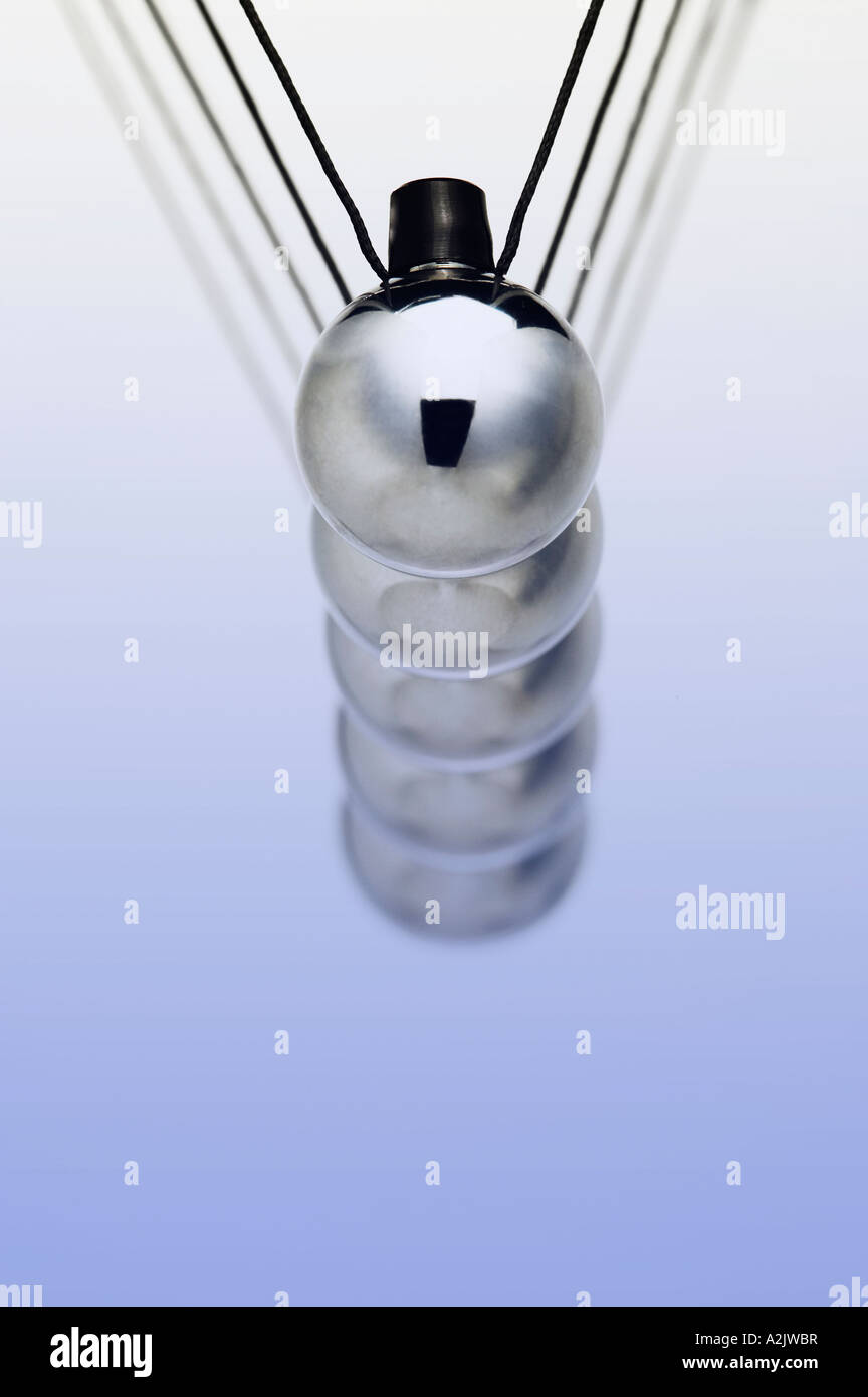 Newtons cradle, with balls in a row, portrait format Stock Photo - Alamy